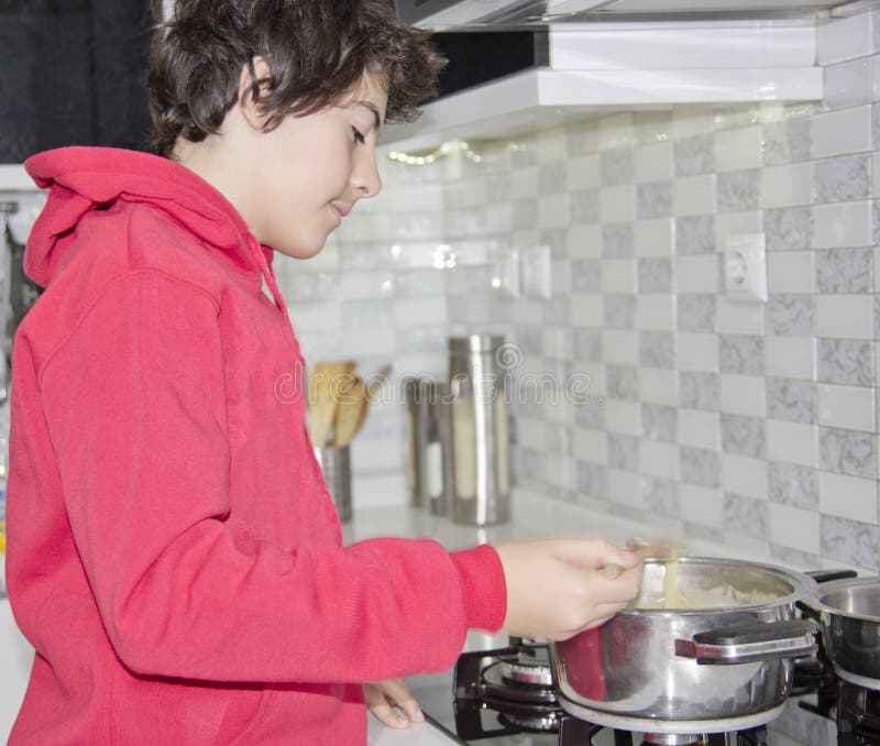 Happy Boy is in Kitchen on a Stove Cooking Soup Stock Image - Image of ...