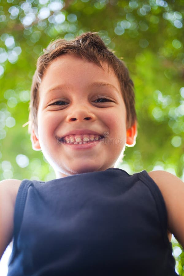 Happy Boy Laughing in Sunlight Stock Photo - Image of outdoors, playful ...