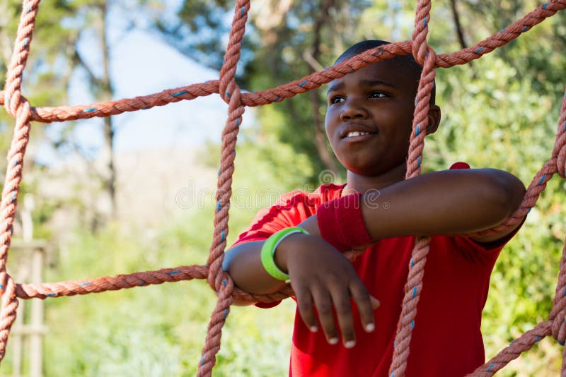 Happy Boy Leaning on Net during Obstacle Course Stock Image - Image of ...