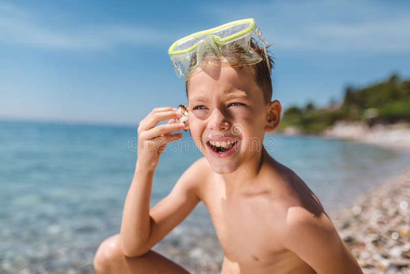 Boy Listen To Seashell at the Beach Stock Image - Image of seaside ...