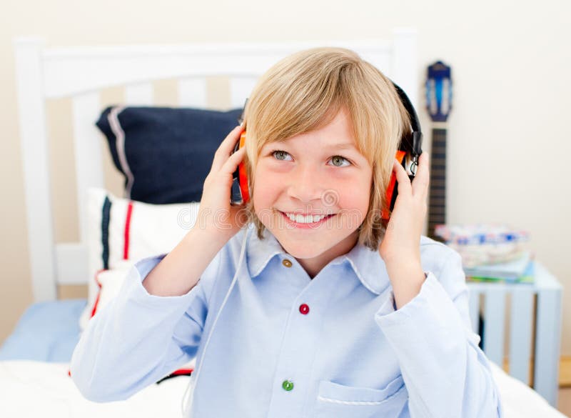 Happy Boy Listening Music Sitting on Bed Stock Photo - Image of ...