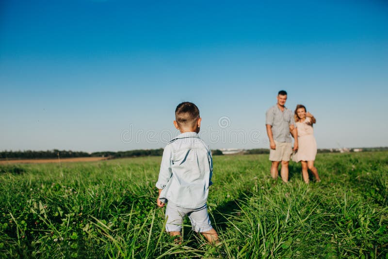 Happy Boy with Parents Running in Park Stock Image - Image of people ...