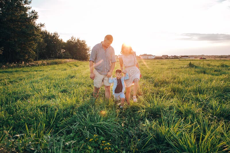 Happy Boy with Parents Running in Park Stock Image - Image of laughing ...