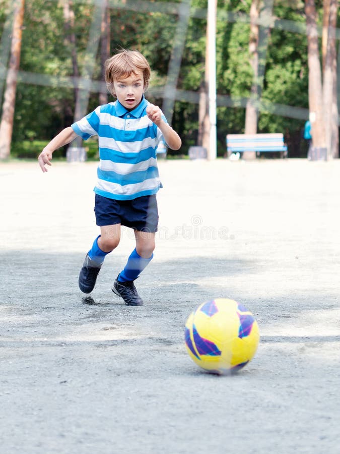 Happy boy playing football stock photo. Image of strong - 34288560