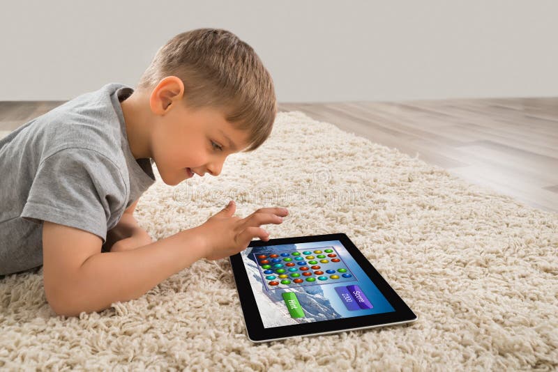Happy Boy Playing Game on Digital Tablet Stock Photo - Image of ...