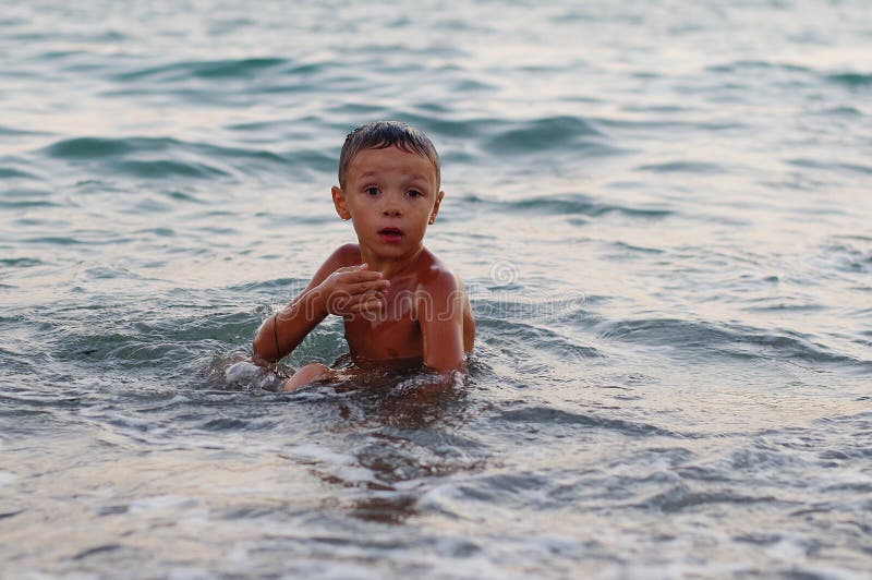 A Happy Boy is Playing in the Waves on the Beach. Stock Image - Image ... A Happy Boy is Playing in the Waves on the Beach. Stock Image - Image ...