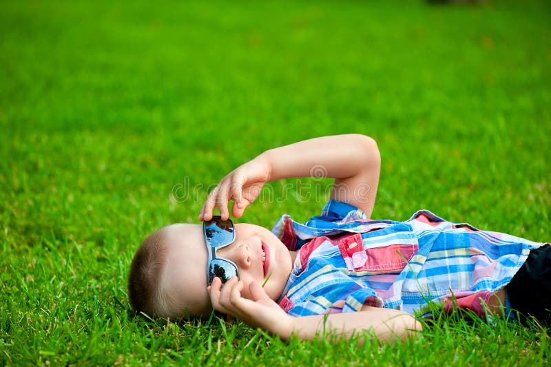 Happy Boy Resting Lying on Green Grass Stock Image - Image of activity ...