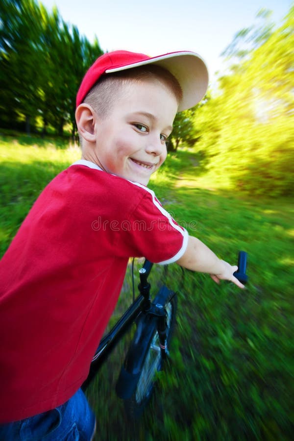 Happy boy rides a bike stock image. Image of nature, movement - 24963305