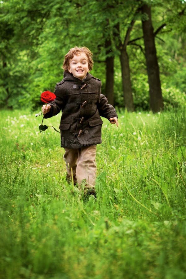 Happy boy running on grass stock photo. Image of face - 25184652