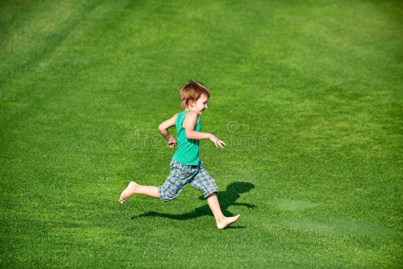 Happy Boy Running at the Green Golf Course at Sunny Day Stock Photo ...