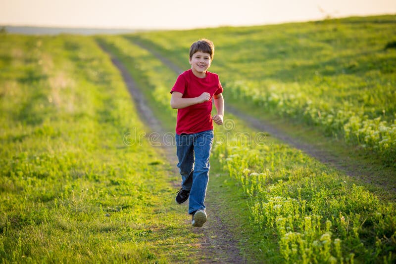 Happy Boy Running on Rural Road with Green Grass Stock Photo - Image of ...