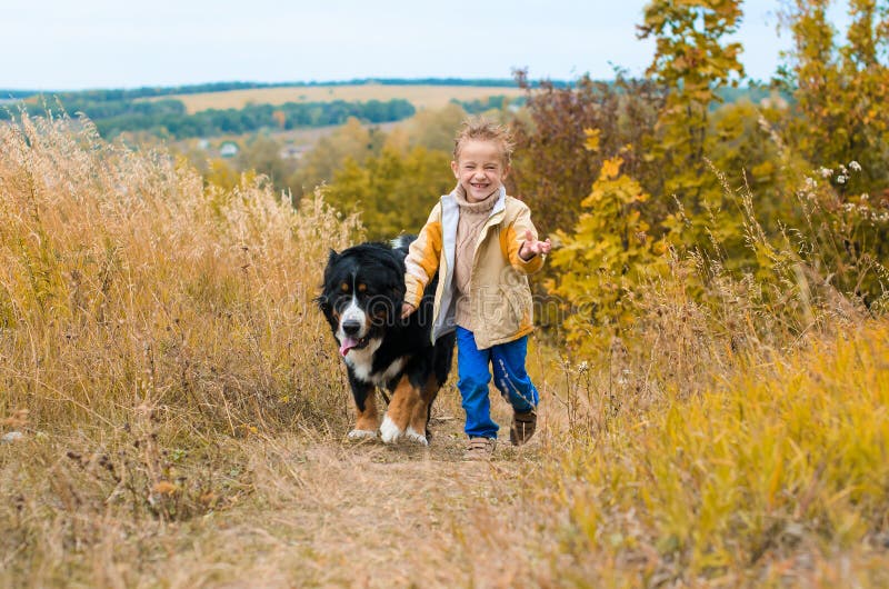 Boy Runs Around with Big Dog on Autumn Hills of Race Stock Image ... Boy Runs Around with Big Dog on Autumn Hills of Race Stock Image ...