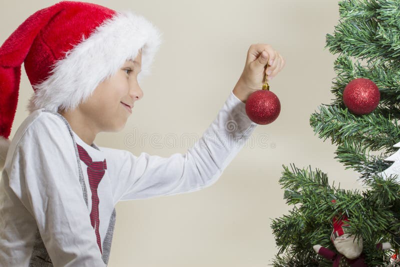 Happy Boy in Santa Cap Decorating Christmas Tree Stock Photo - Image of ...