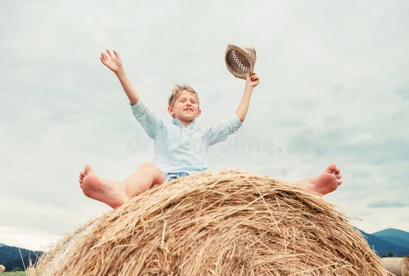 Barefoot Boy Sleeps on the Grass Near Ladder in Haystack Stock Photo ...