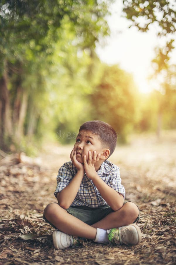 Happy Boy Sitting and Thinking Alone Stock Image - Image of cute ...