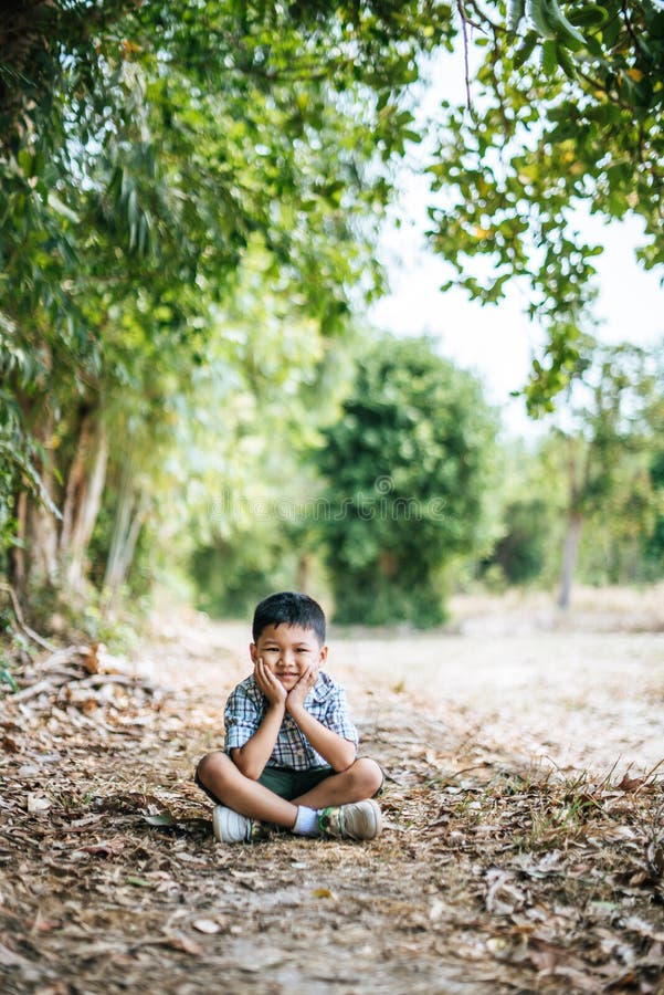 Happy Boy Sitting and Thinking Alone Stock Photo - Image of caucasian ...