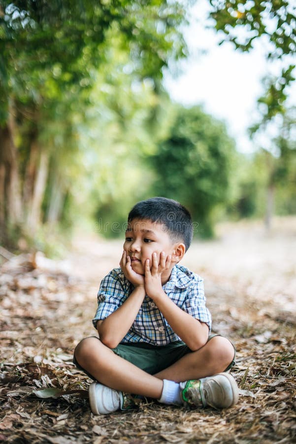 Happy Boy Sitting and Thinking Alone Stock Image - Image of handsome ...