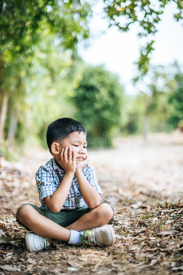 Happy Boy Sitting and Thinking Alone Stock Photo - Image of spring ...
