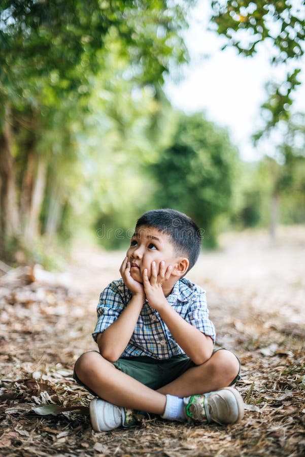 Happy Boy Sitting and Thinking Alone Stock Image - Image of face, happy ...