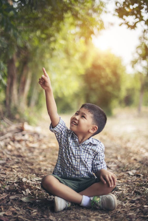 Happy boy playing alone stock photo. Image of playing - 167796304