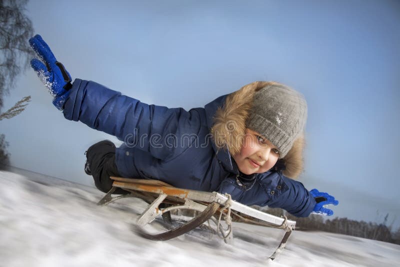 Happy boy on sled stock photo. Image of leisure, male - 58364988