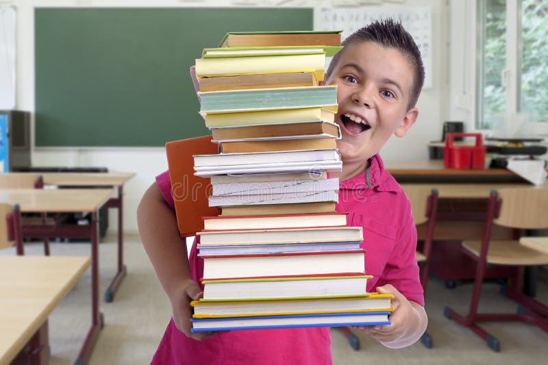 Happy Boy with Stack of Books in a Classroom Stock Image - Image of ...
