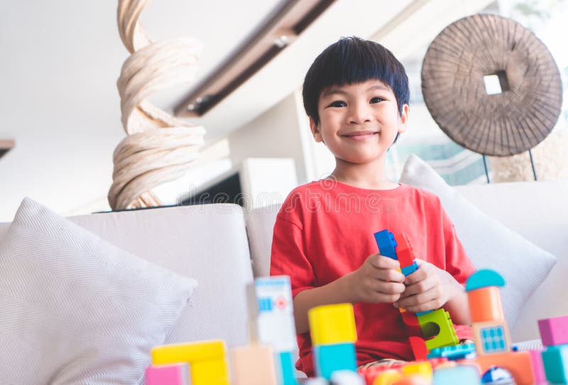 Boy Stacking Toy Blocks on a Living Room for Educational Toy Stock ...