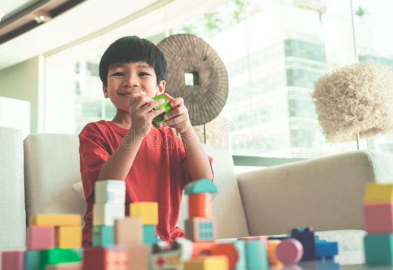 Boy Stacking Toy Blocks on a Living Room for Educational Toy Stock ...