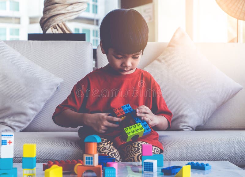 Boy Stacking Toy Blocks on a Living Room for Educational Toy Stock ...