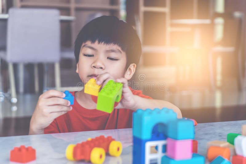 Boy Stacking Toy Blocks on a Living Room for Educational Toy Stock ...