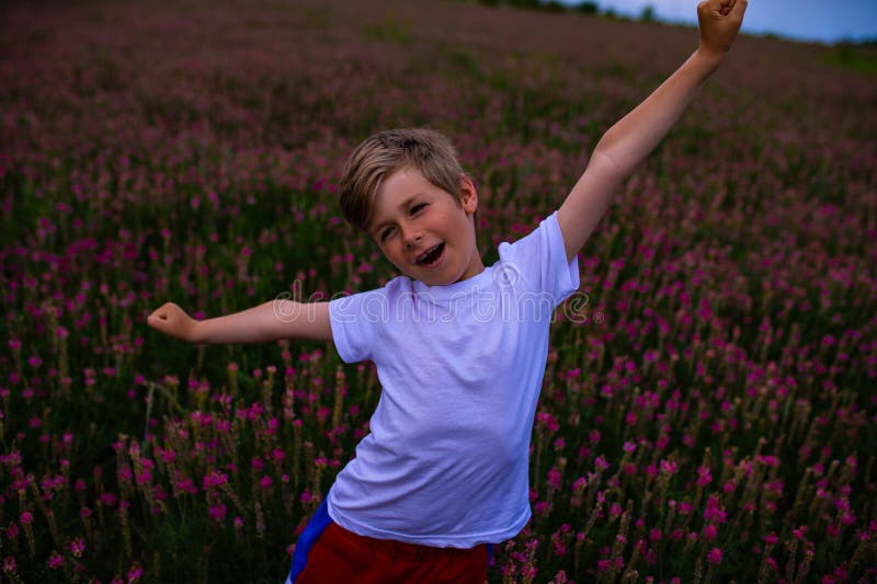 Happy Boy Stretching in Flower Meadow at Twilight Stock Photo - Image ...