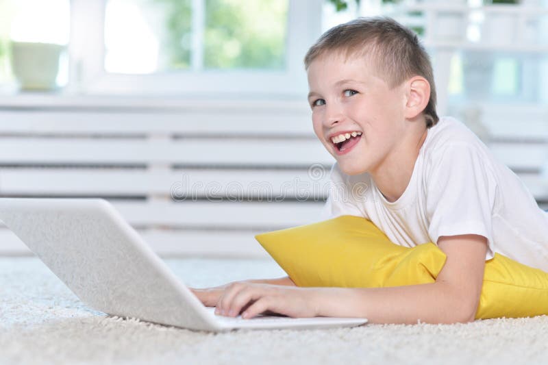 Young Boy and Laptop Computer Stock Image - Image of lying, online ...