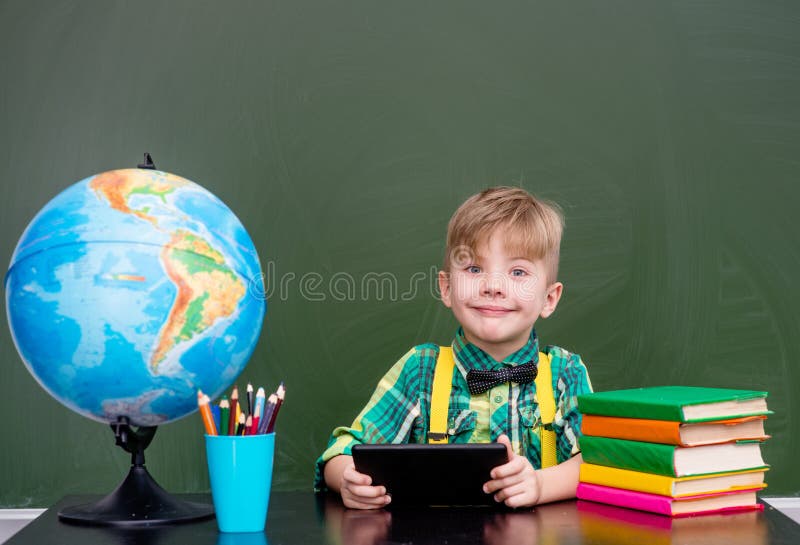 Happy Boy Using Tablet Computer in Classroom Stock Photo - Image of ...