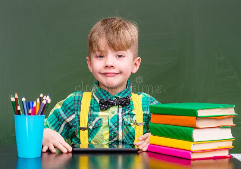 Happy Boy Using Tablet Computer in Classroom Stock Photo - Image of ...