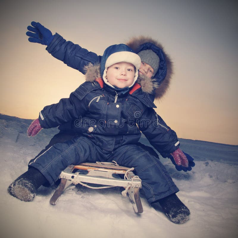 Happy boys on sled stock image. Image of childhood, cold - 35720593
