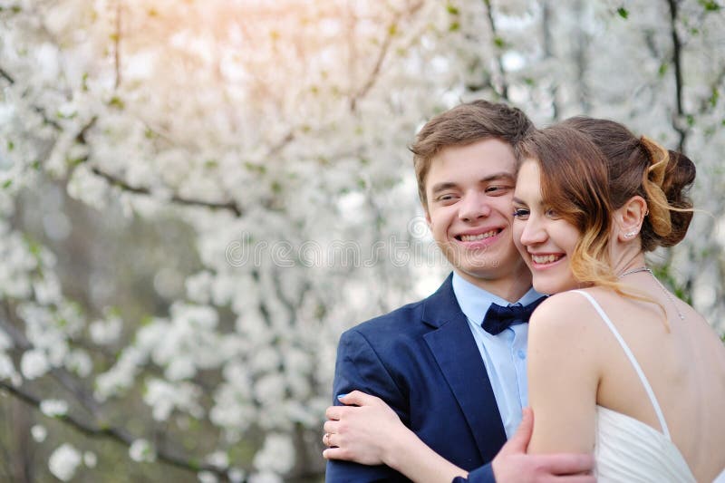 Happy Bride and Groom in a Blossoming Spring Garden Stock Photo - Image ...