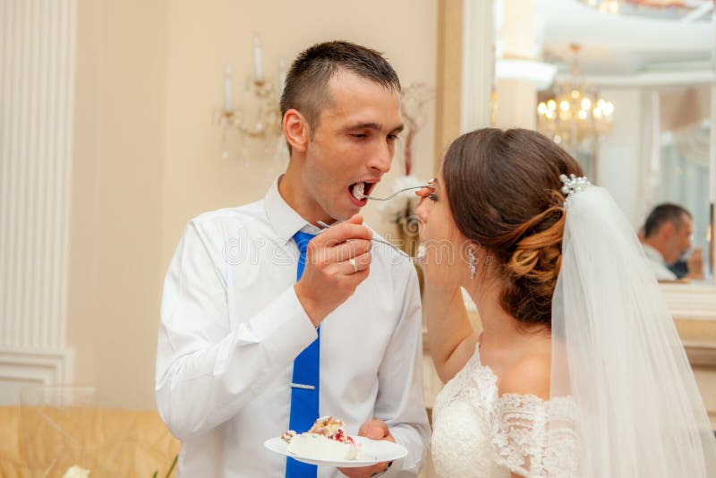 Bride and Groom Eat Wedding Cake Stock Image - Image of fashion ...