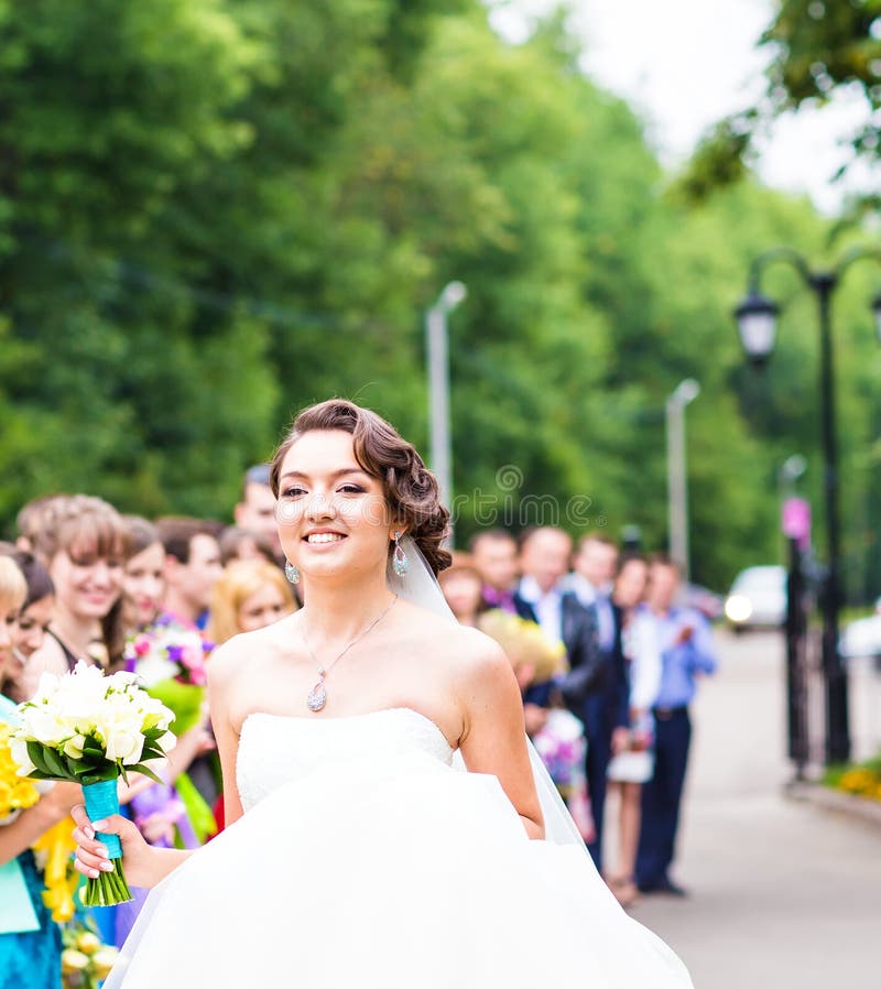 Happy bride with guests stock image. Image of bridal - 68407095