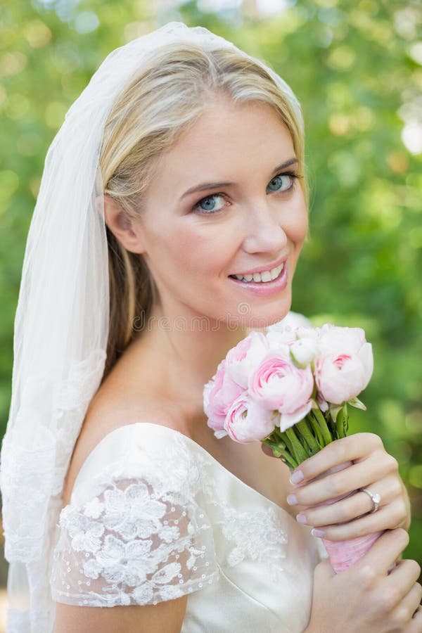 Happy Bride Holding Her Bouquet Smiling at Camera Stock Photo - Image ...