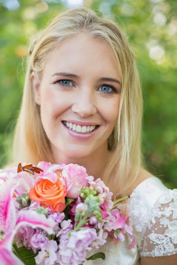 Happy Bride Looking at Camera Holding Bouquet Stock Image - Image of ...