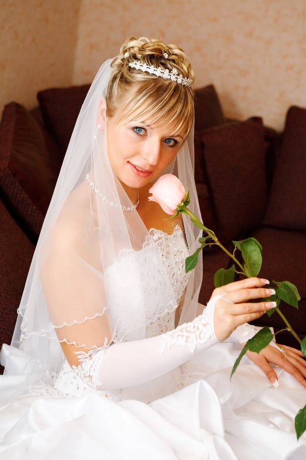 Happy bride with rose stock photo. Image of looking, indoors - 9182844