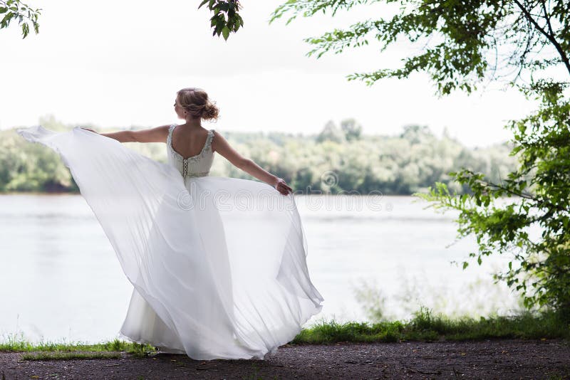 Happy Bride in a Wedding Dress is Spinning. Stock Photo - Image of ...