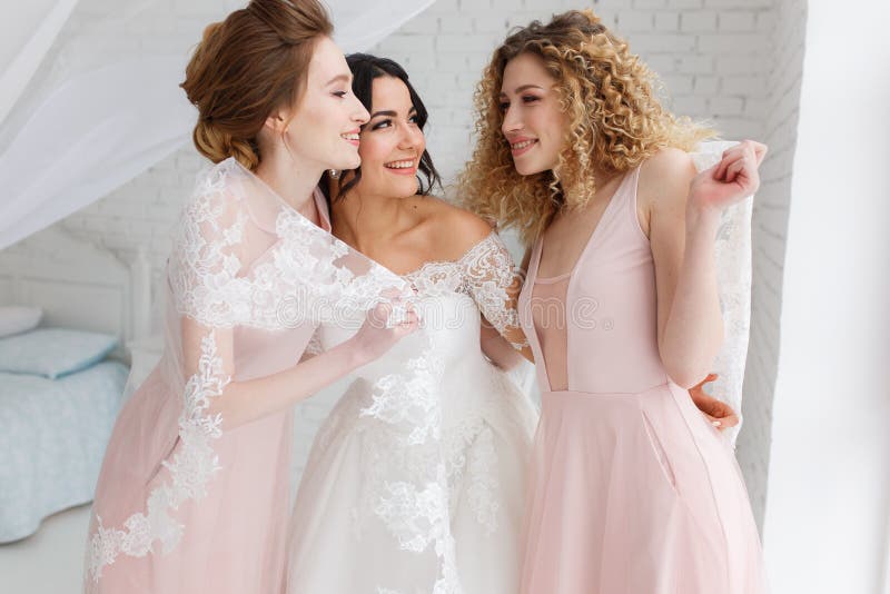 Happy Bridesmaid Hugging the Bride in the Bedroom in the Morning Stock ...