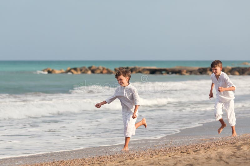 Happy Brothers Playing on Beach, Spain Stock Photo - Image of seaboard ...