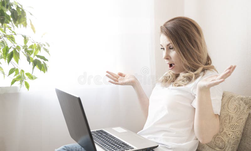 Happy Brunette Woman Using Laptop While Sitting On Bed In The Morning