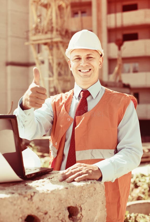 Happy Builder in Building Site Stock Photo - Image of laptop, device ...