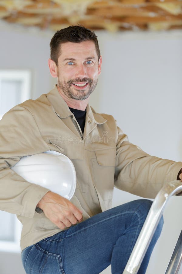 Happy builder on ladder stock image. Image of architect - 196545703