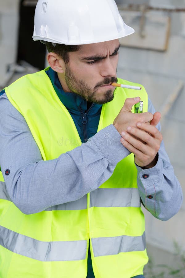 Happy Builder Smoking Cigarette on Construction Site Stock Image ...