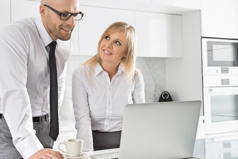 Happy Business Couple Working on Laptop in Kitchen Stock Image - Image ...