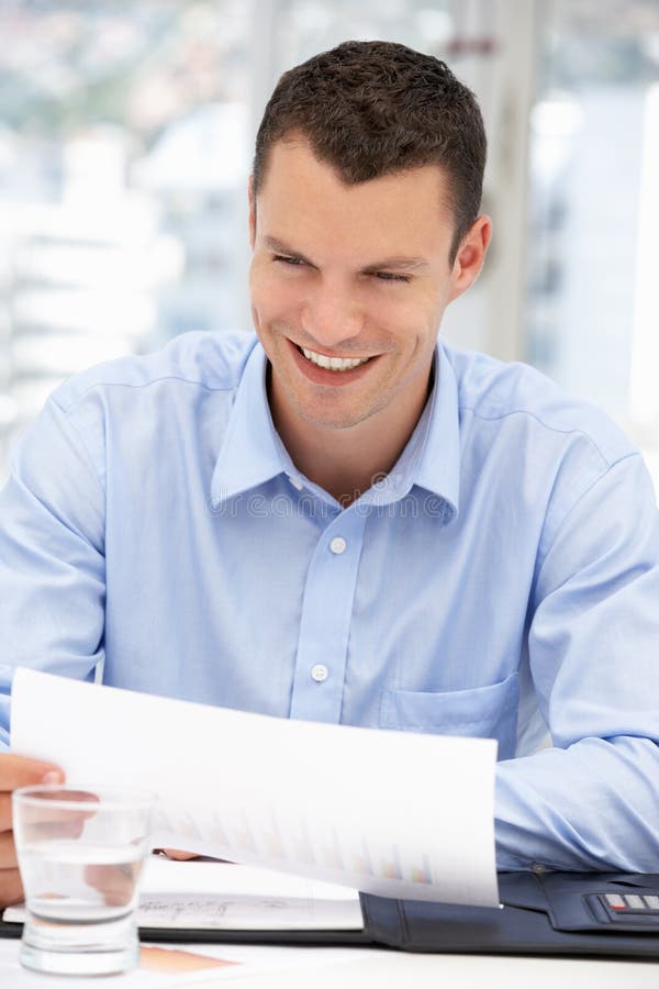 Happy Business Man Reading Notes in Office Stock Image - Image of young ...
